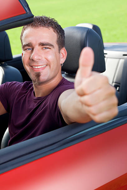 Free Stock Photo of A young man getting into a red convertible sports ...