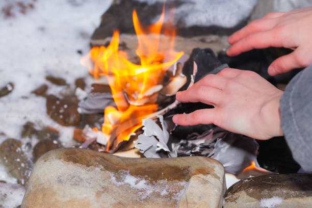 Free Stock Photo of Child warming hands over a cozy outdoor fire ...