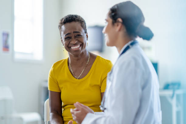 Free Stock Photo of Patient laughing with doctor during checkup ...