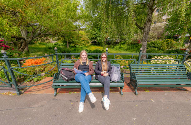 Free Stock Photo of Photo of two women sitting on a bench with crossed ...