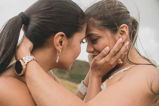 Couple Of Two Women Wives Looking At Each Other Face To Face While
