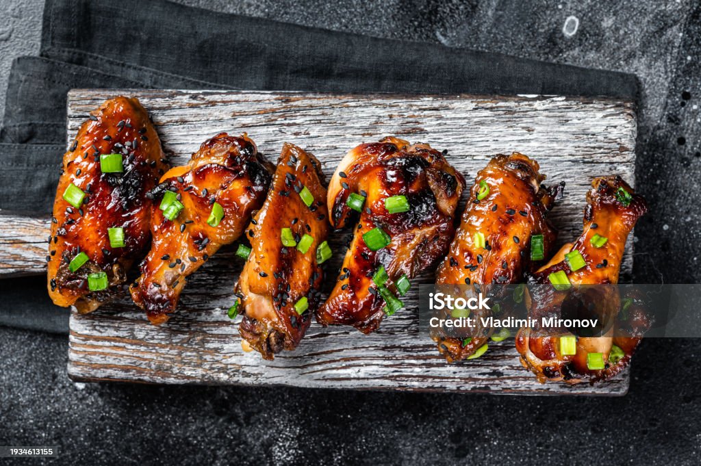 Chicken Buffalo Wings In Sweet And Sour Sauce With Black Sesame Black Background Top View Stock