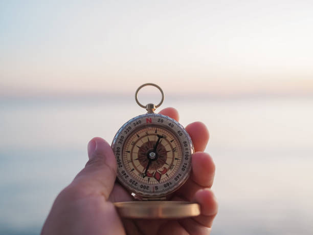 Free Stock Photo of Person Holding Compass by Water | Download Free ...