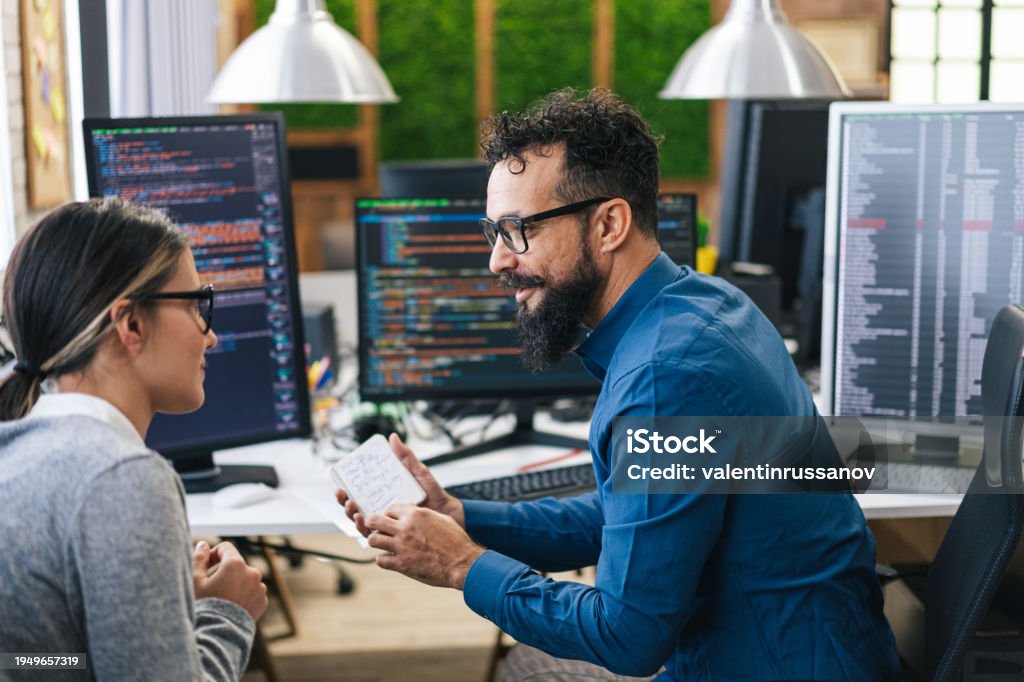 Software Programmers Analyzing Html Code And Database Brainstorming Script Ideas To Develop New