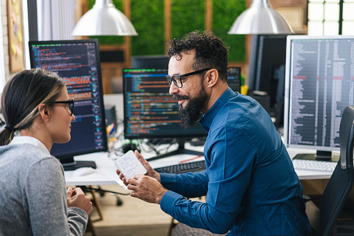 Software Programmers Analyzing Html Code And Database Brainstorming Script Ideas To Develop New