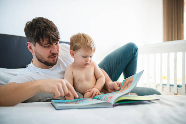 Free Stock Photo of Young Father Reading Book For Little Baby ...
