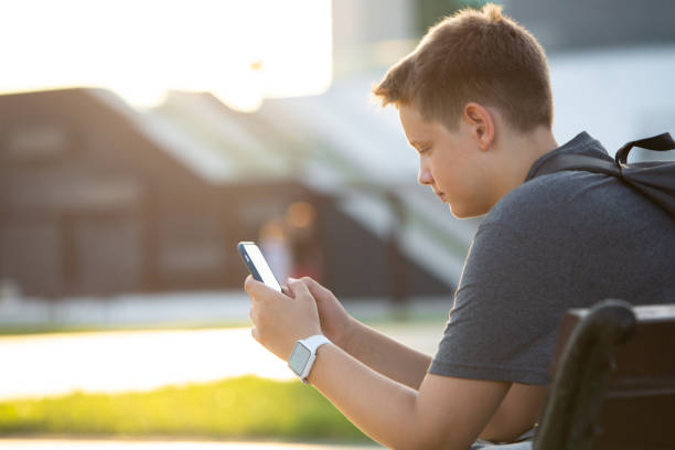 Free Stock Photo of Young Boy Using Cellphone on Stairs | Download Free ...