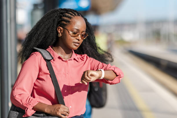 Free Stock Photo of Young woman checking the time in urban setting ...