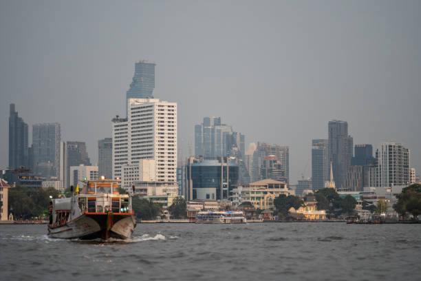 Free Stock Photo of Boats Floating Down River Next to Tall Building ...