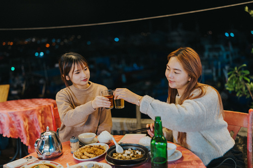 Two Young Asian Girl Enjoying Dinner At A Dai Pai Dong In Cheung Chau An Type Of Hong Kongs