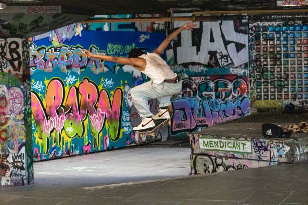 Free Stock Photo of Skateboarder performing trick on graffiti ledge ...