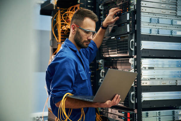 Free Stock Photo of Technician working on network server equipment ...