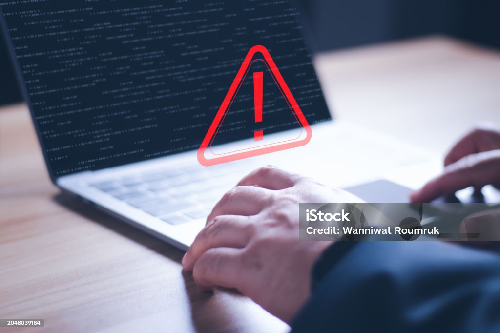 Hacker Or Programmer Using Laptop With Triangle Caution Warning Sign