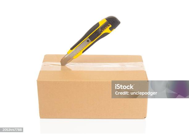 Unboxing Of Parcel With Utility Knife Close Up Isolated On White
