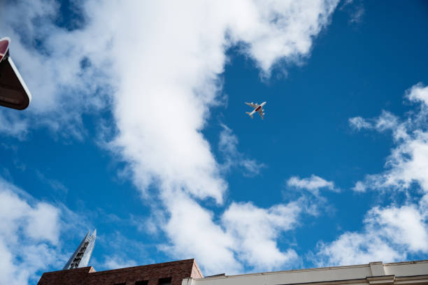 Free Stock Photo of Airplane Flying Over Building With Sky Background ...