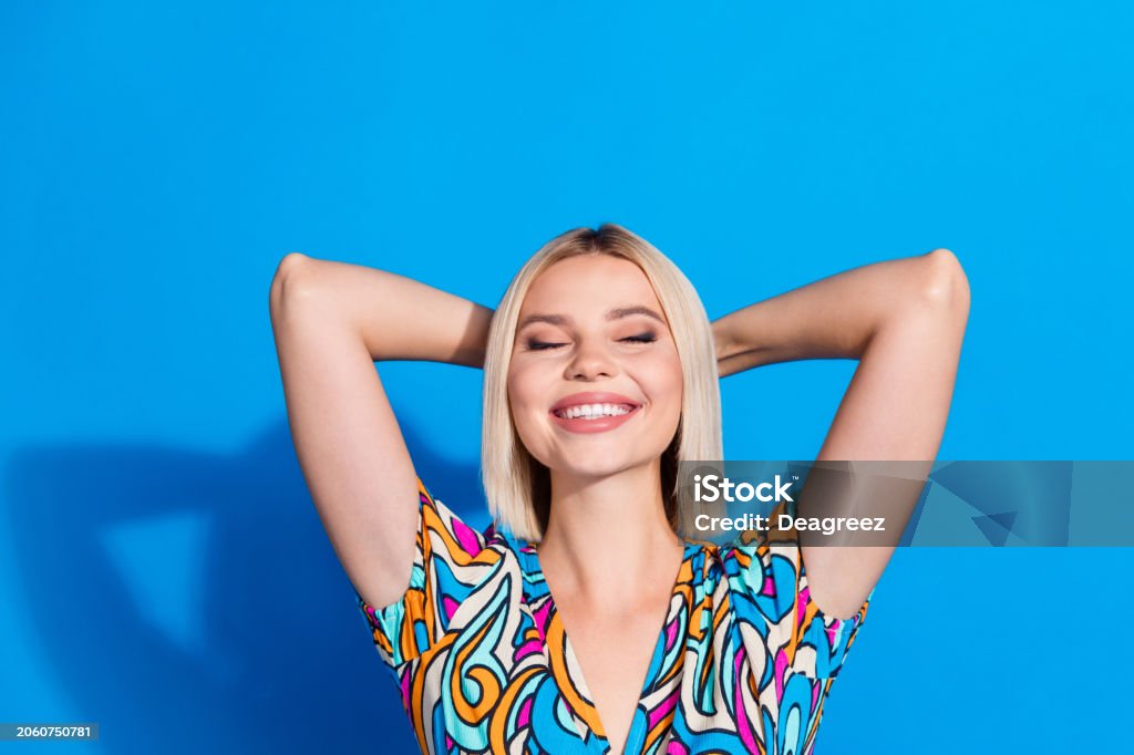 Photo Of Good Mood Woman With Bob Hairdo Dressed Print Blouse Arms Behind Head Eyes Closed