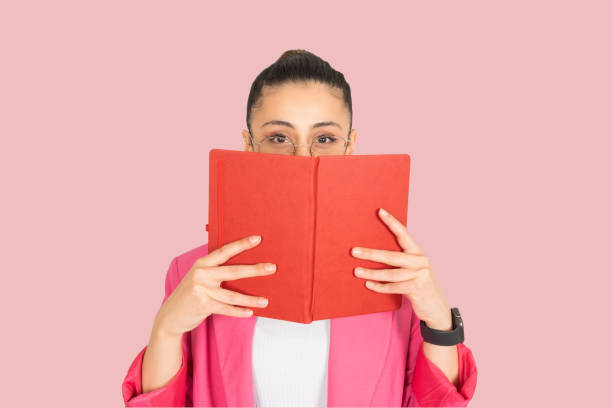 Free Stock Photo of Woman Hiding Face Behind Book | Download Free ...