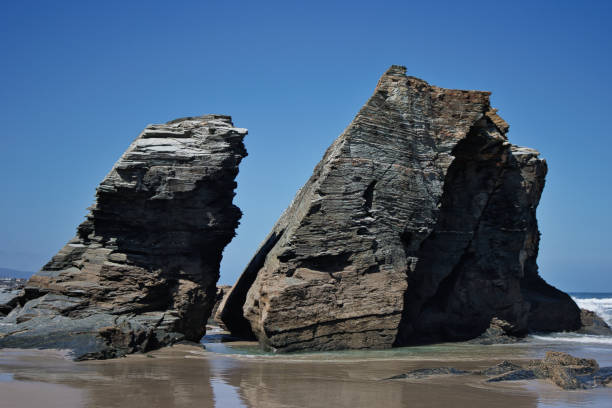 Free Stock Photo of Massive Rock Formation on Beach by Ocean | Download ...