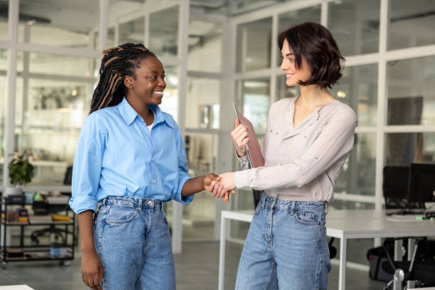 Free Stock Photo of Friendly handshake between two women in an office ...