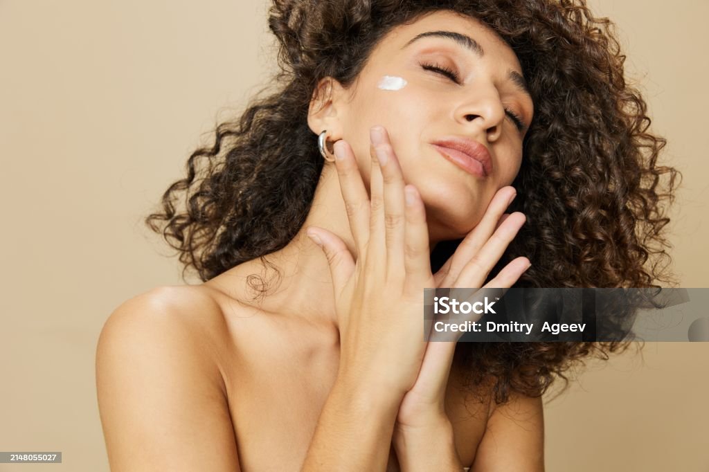 Woman Beauty Face Closeup Applying Antiaging Moisturizer With Fingers