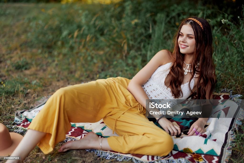 Young Beautiful Hippie Woman Lying On The Ground In Nature In The Fall