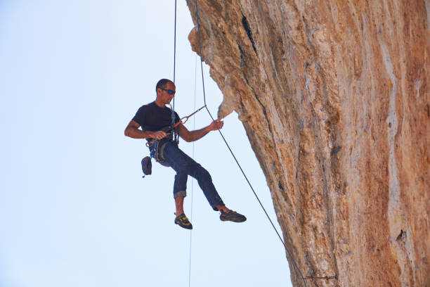 Free Stock Photo of Man Hanging From Rope on Mountain Side | Download ...