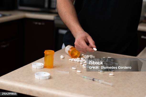 Man Trying To Inject A Sustance With A Syringe And A Table Full Of ... Man Trying To Inject A Sustance With A Syringe And A Table Full Of ...