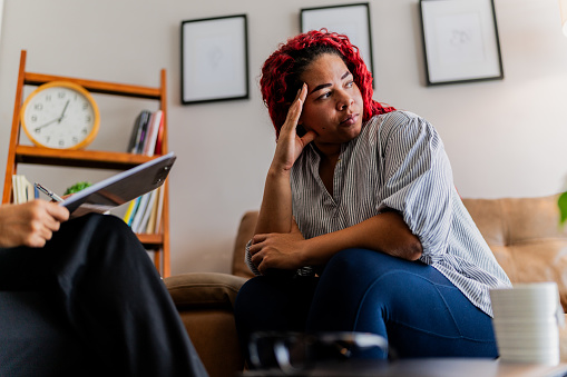 Sad Mid Adult Woman Being Comforted By Psychotherapist During Therapy