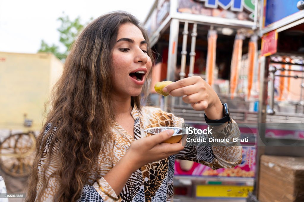 Young Indian Woman Eating Pani Puri Golgappa On Roadside Street Food ... Young Indian Woman Eating Pani Puri Golgappa On Roadside Street Food ...
