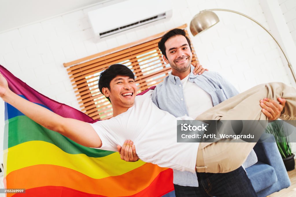 Happy Caucasian And Asian Lgbt Couple Standing And Waving Under The