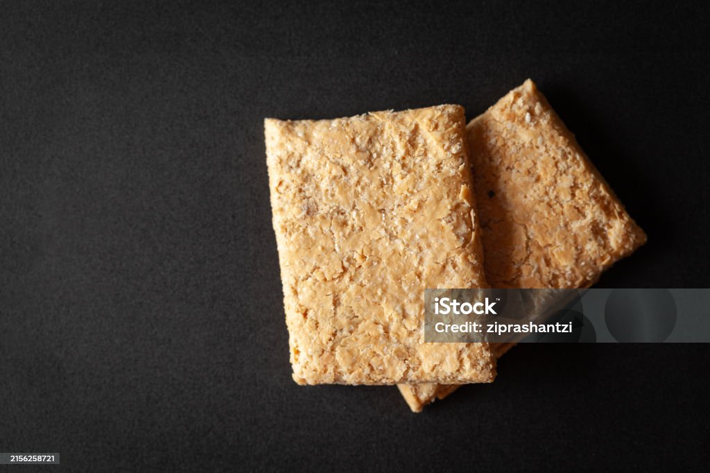 Two Pieces Of Indian Mithai A Delicate Soft Crunchy Gajak Bar Made Of