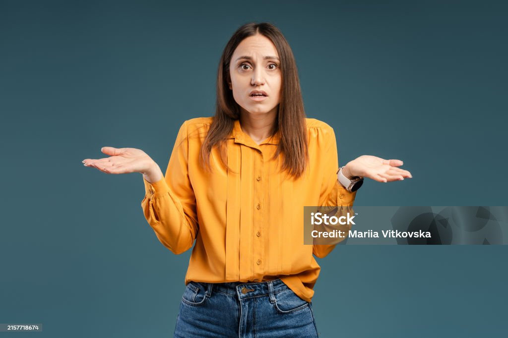 Beautiful Woman Spreading Her Arms To The Side In Surprise Posing In
