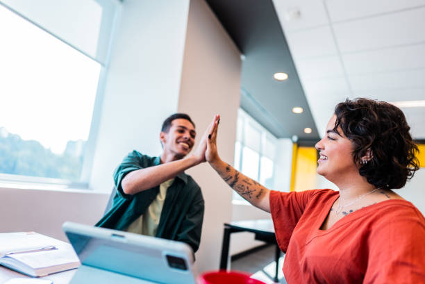 Free Stock Photo of Coworkers giving high five in the cafe booth ...