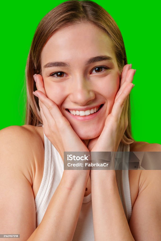 Portrait Of A Happy Young Woman With Hands On Cheeks Green Screen