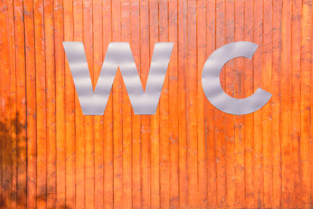 Free picture: WC toilet sign with arrow on orange yellow metal