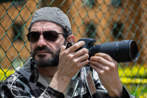 Free Stock Photo of Young male photographer behind chain fence ...