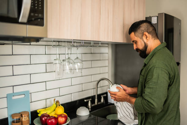Free Stock Photo of Adult male washing dishes in the kitchen at home ...