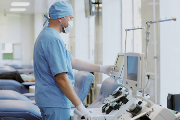 Free Stock Photo of Medical Professional in Scrubs and Mask Operating ...