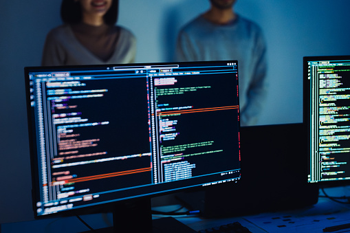 Asian Two Software Developers Engaged In Collaborative Coding Session