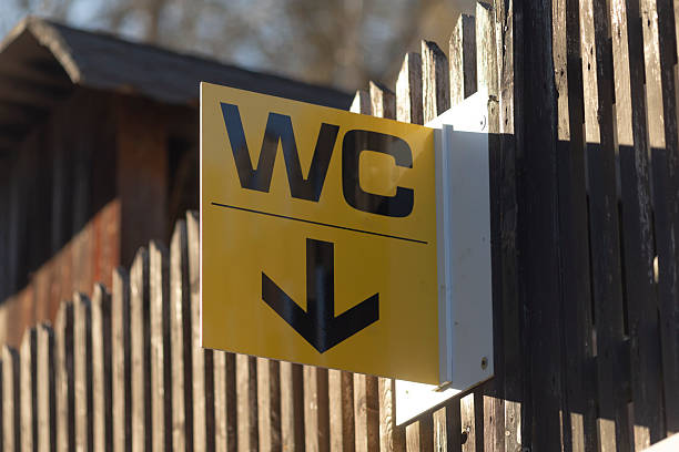 Free picture: WC toilet sign with arrow on orange yellow metal