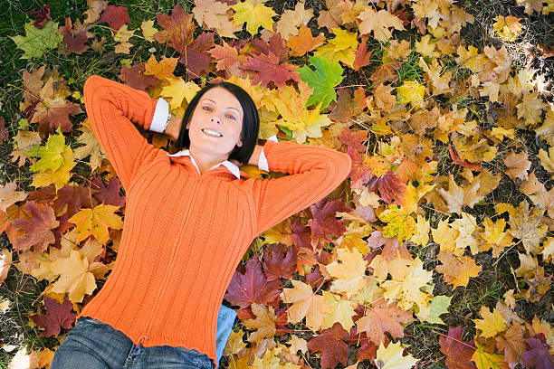 Free Stock Photo of Woman lying down on autumn leaves - hand on chin ...