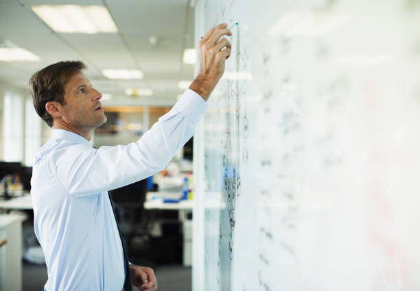 Free Stock Photo of Man writing on whiteboard in office | Download Free ...