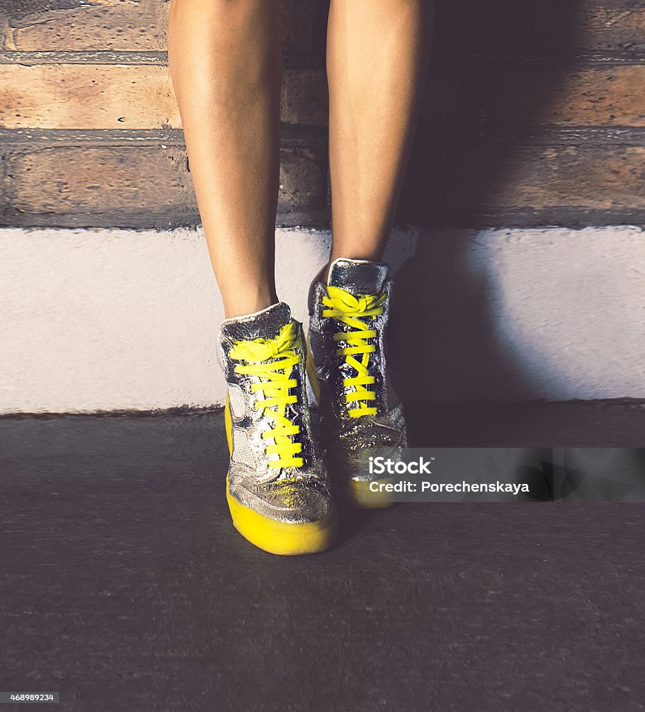 Girl Standing In Fashionable Sneakers Brick Wall Urban Fashion Stock