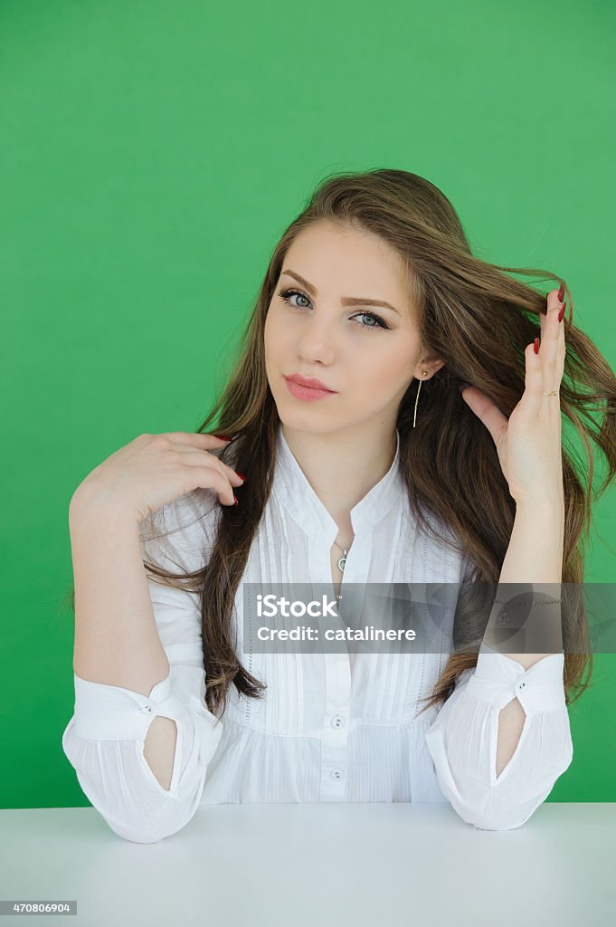 Portrait Of Beautiful Young Woman Over Green Screen Background Stock