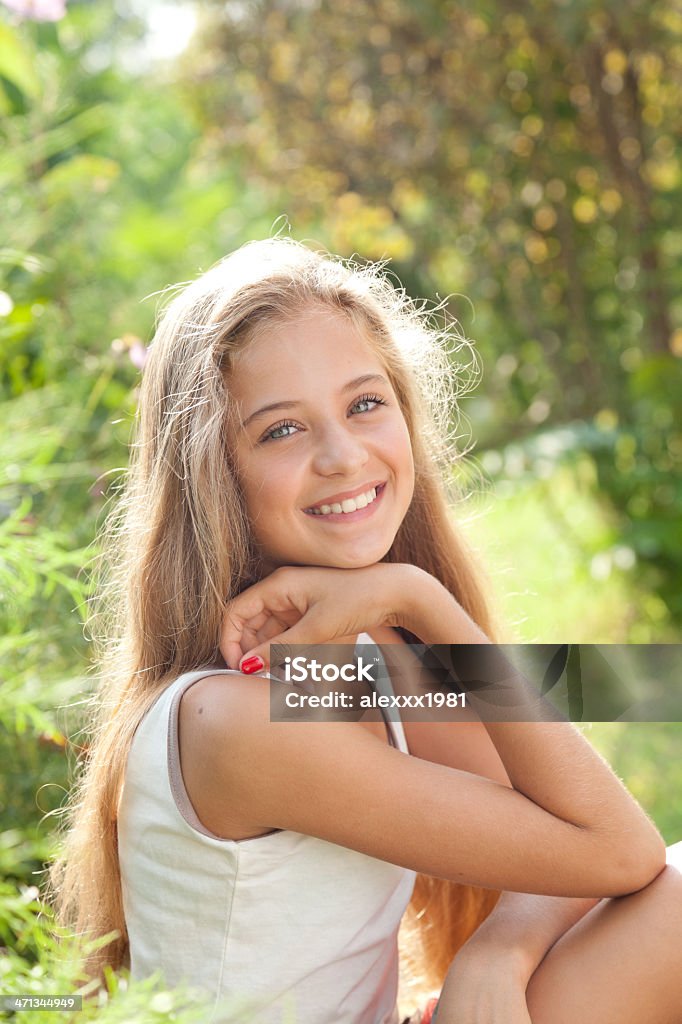 Portrait Of Pretty Teenage Girl Sitting Smiling Enjoying Nature Stock