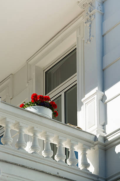Free Stock Photo of A white and red building with a balcony on the side ...