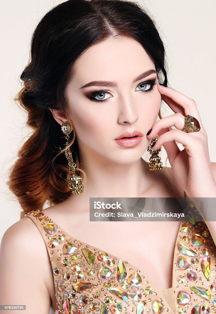 Woman With Dark Hair Wearing Luxurious Sequin Dress And Bijou Stock