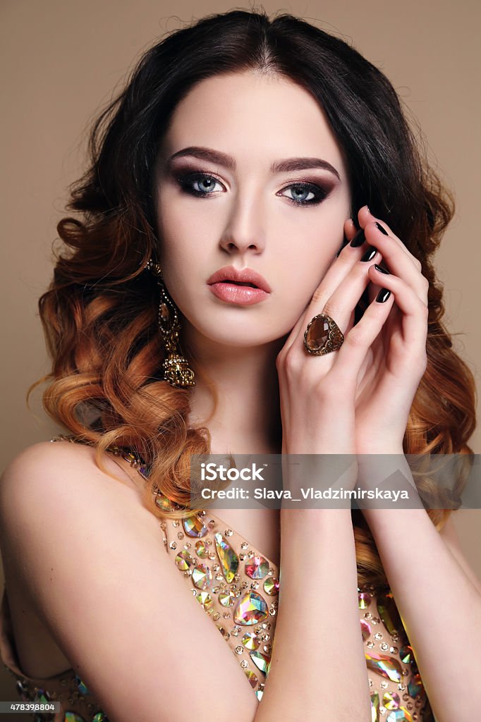 Woman With Dark Hair Wearing Luxurious Sequin Dress And Bijou Stock
