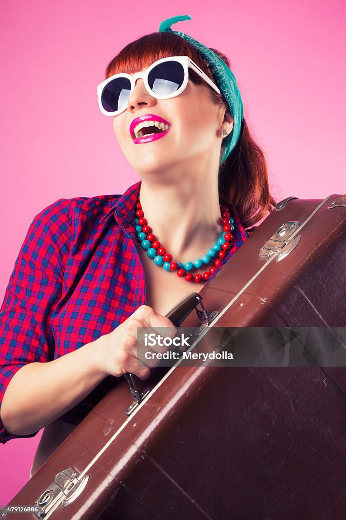 Beautiful Pinup Girl Posing With Vintage Suitcase Against Pink Stock