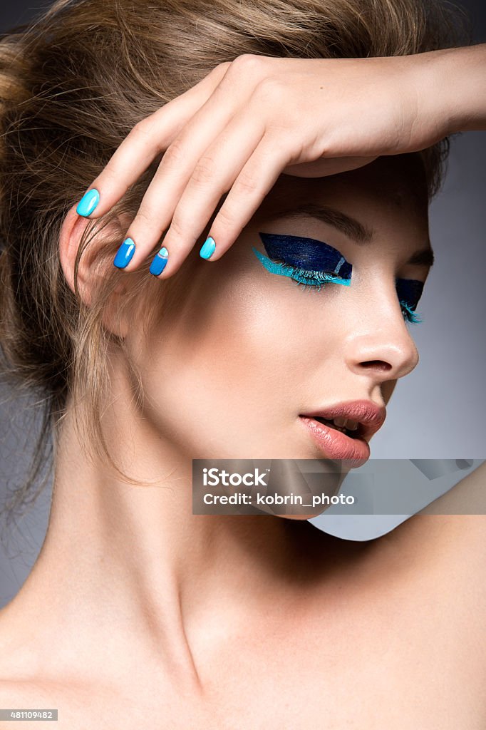 Beautiful Girl With Bright Creative Fashion Makeup And Blue Nail Stock